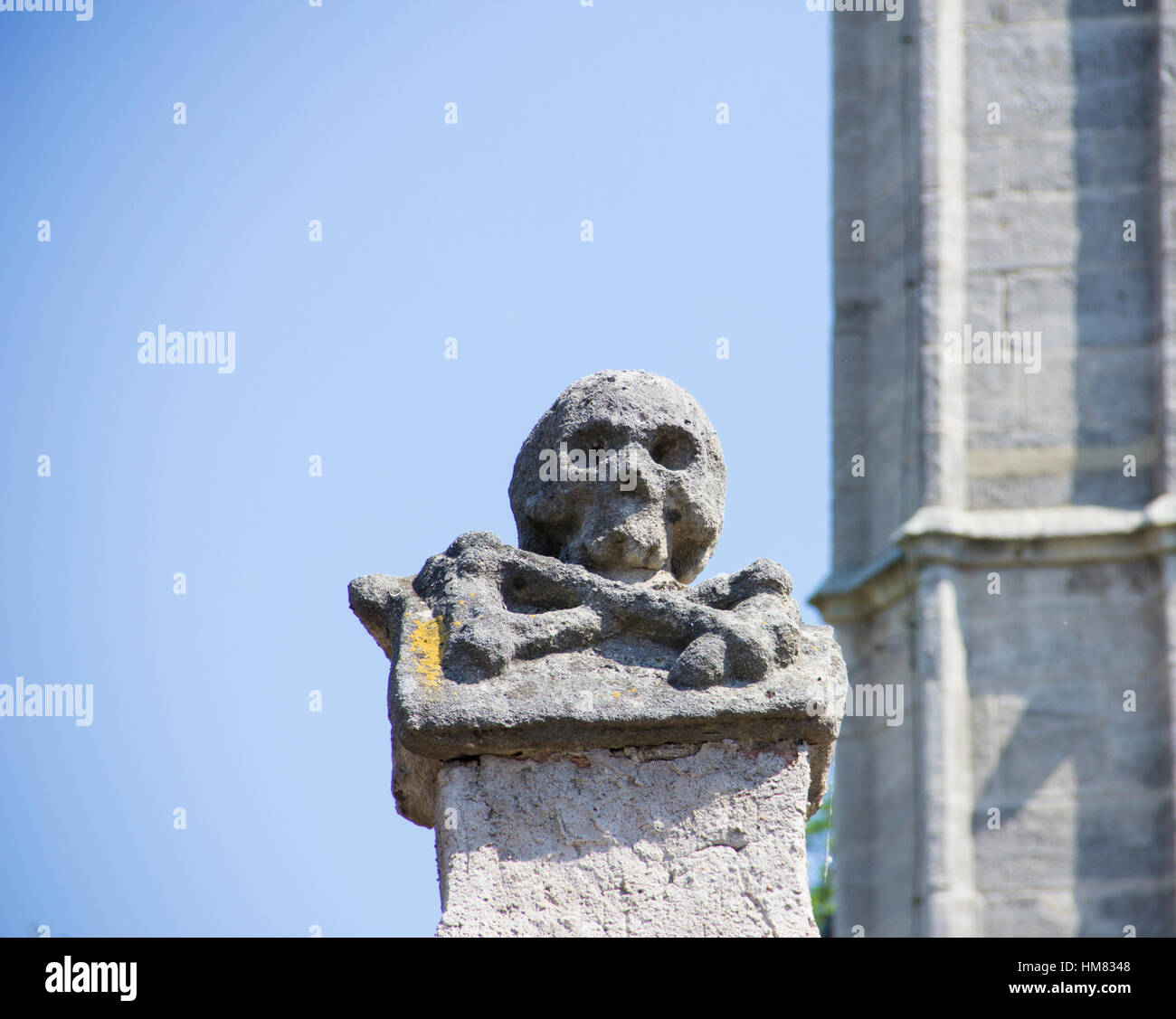 A cement skull outside a cemetery Stock Photo - Alamy