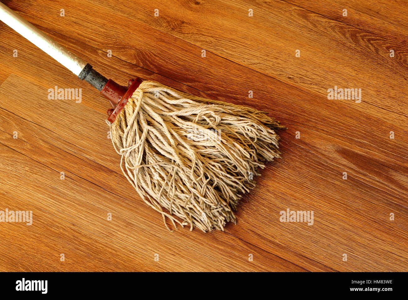 cleaning wooden parquet with old mop Stock Photo - Alamy