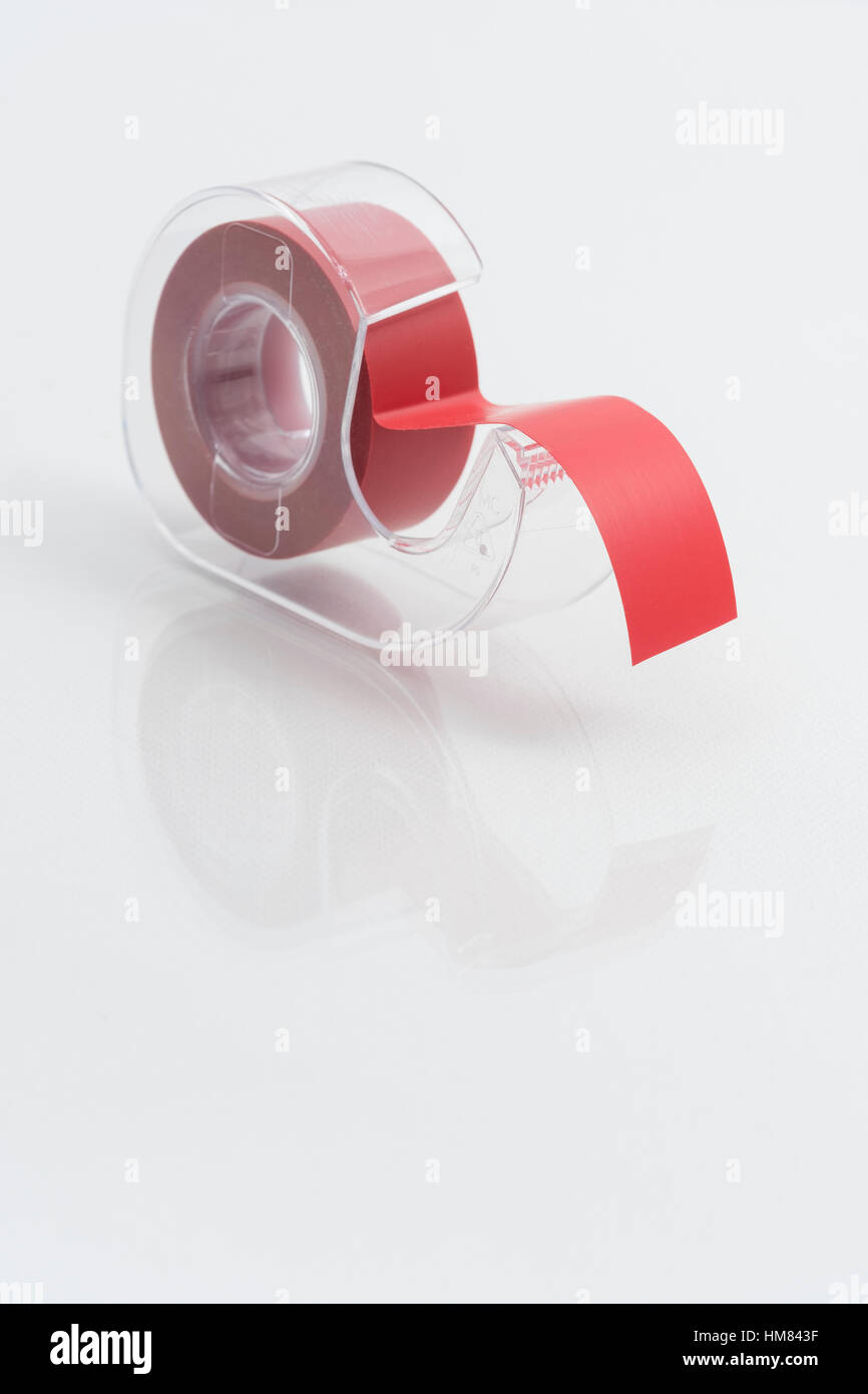 Roll or red tape in a sticky tape dispenser - as visual metaphor for ...