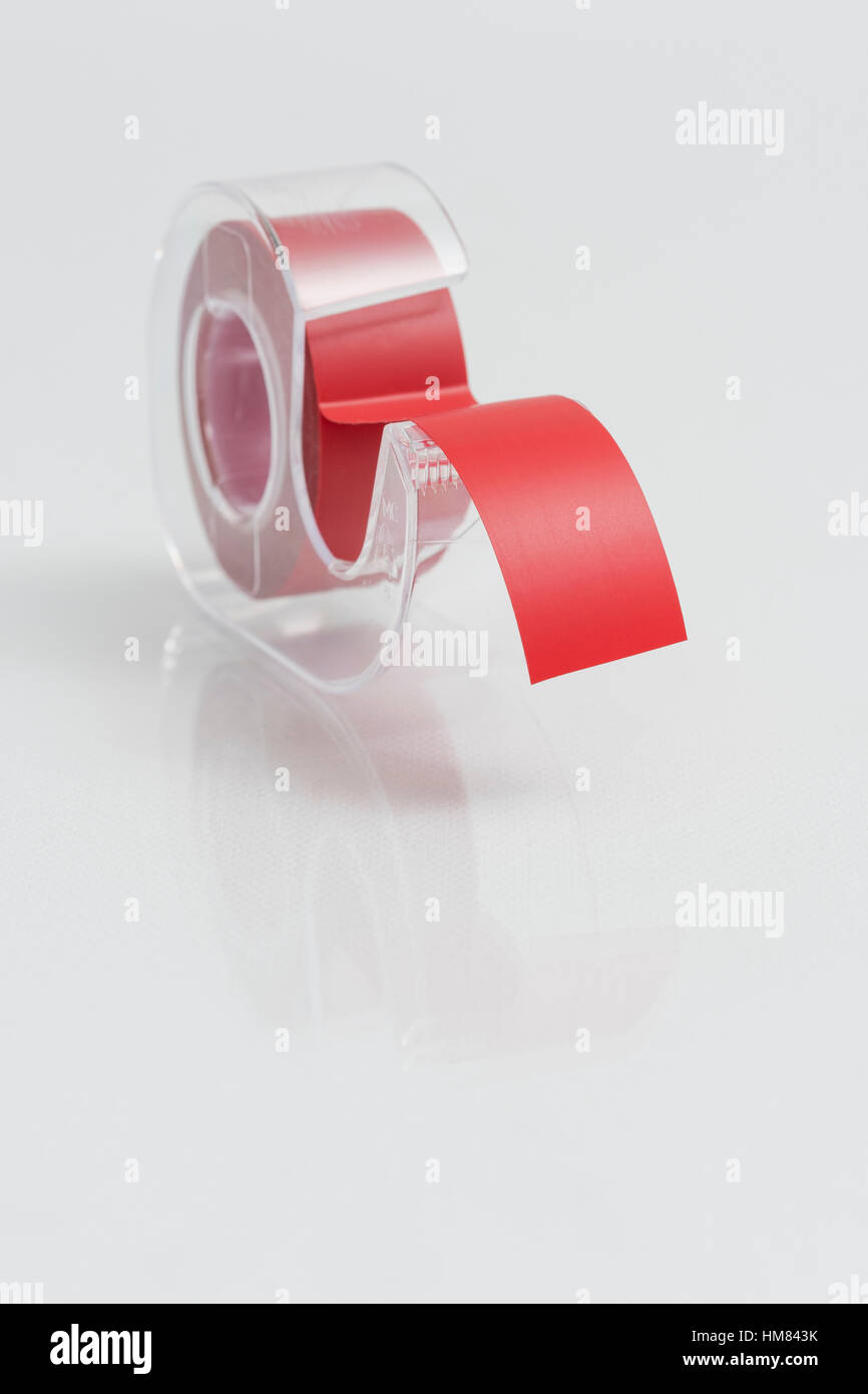 Roll or red tape in a sticky tape dispenser - as visual metaphor for ...