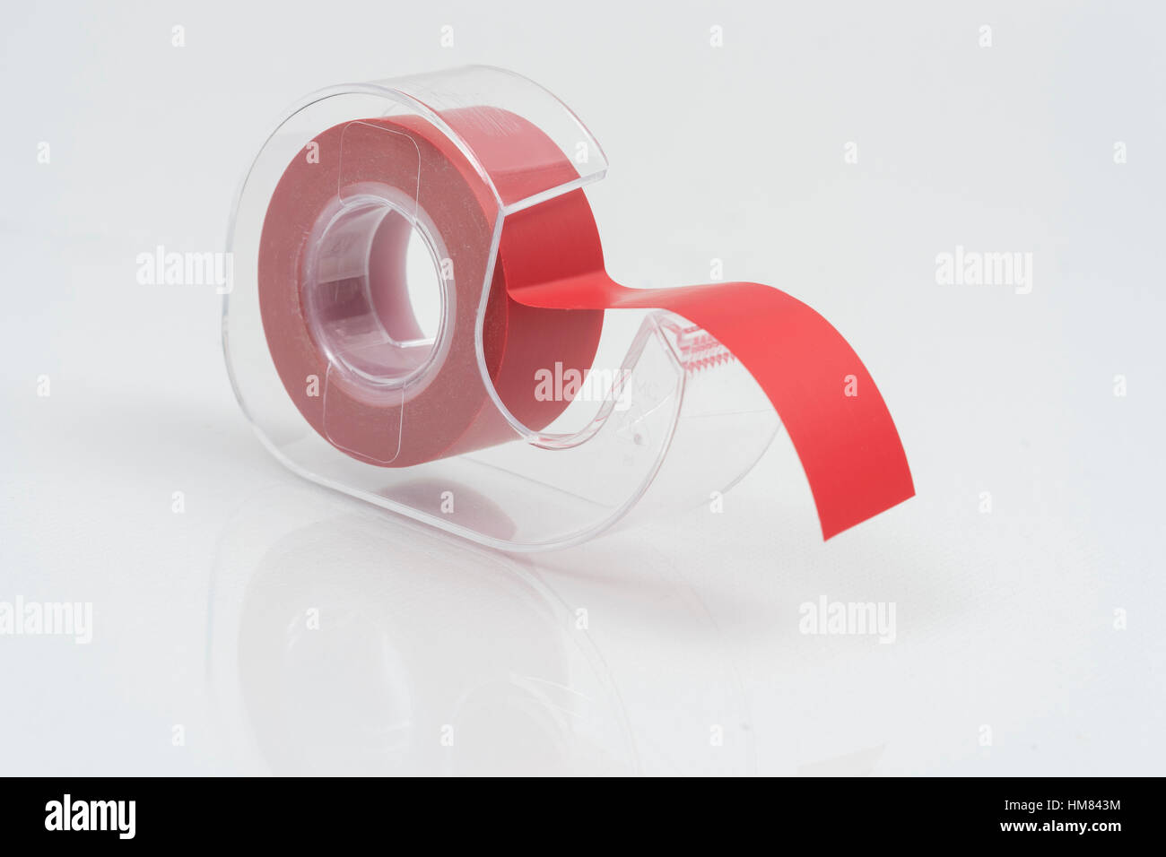Roll or red tape in a sticky tape dispenser - as visual metaphor for ...