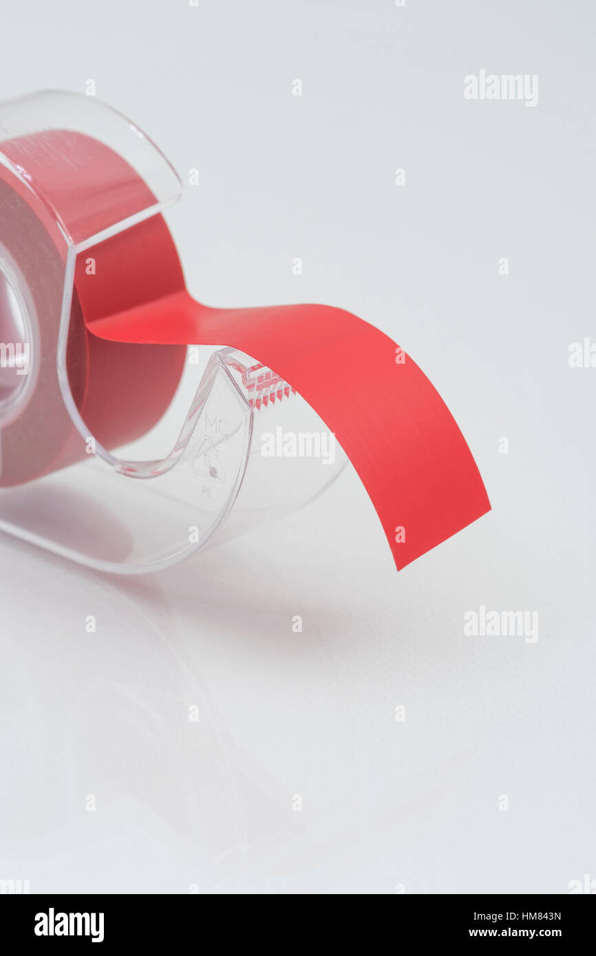 Roll or red tape in a sticky tape dispenser - as visual metaphor for ...
