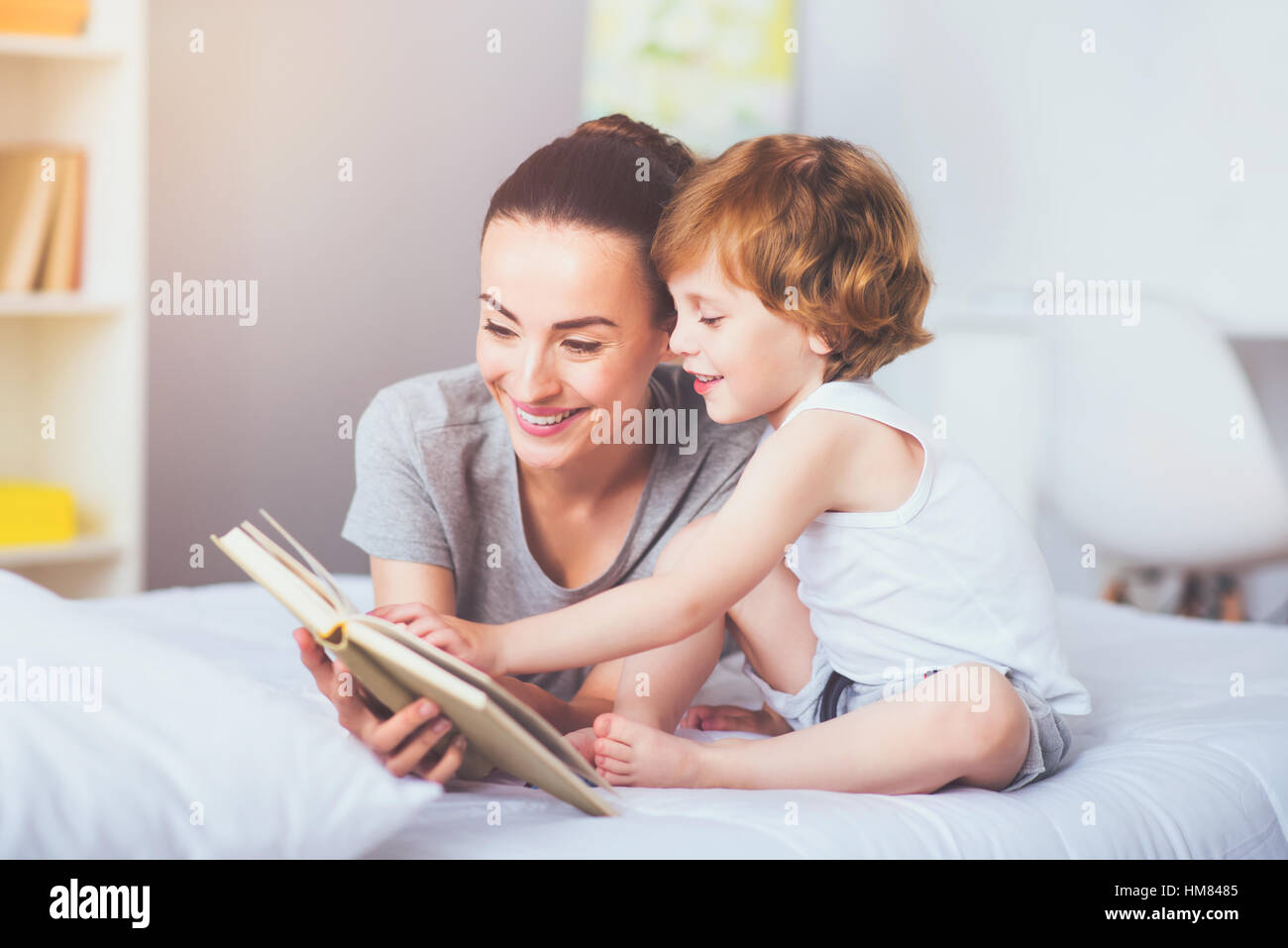 Pretty mother reading a book to her lovely son Stock Photo - Alamy
