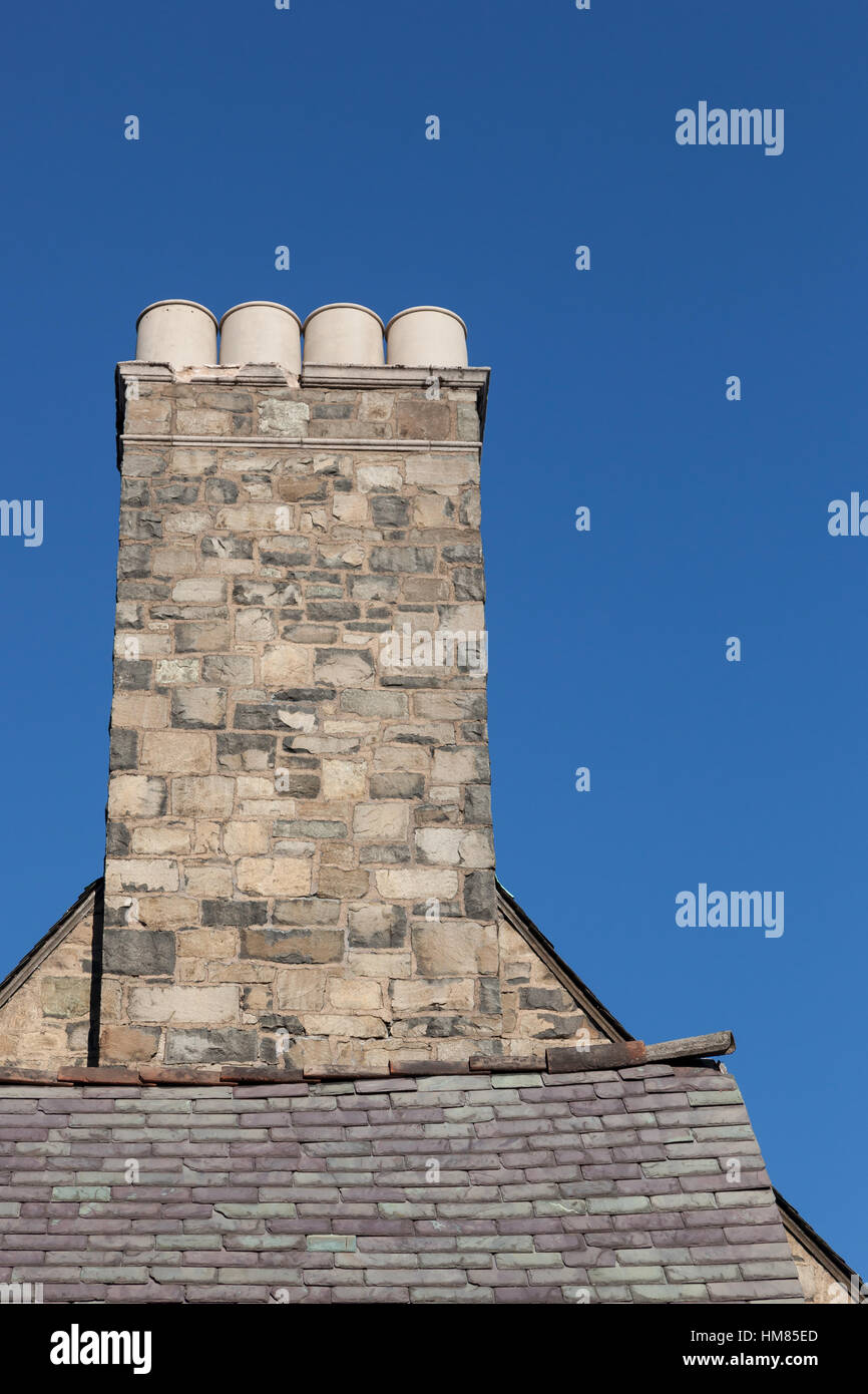 An old stone chimney is visable on a tudor style house. This structure ...