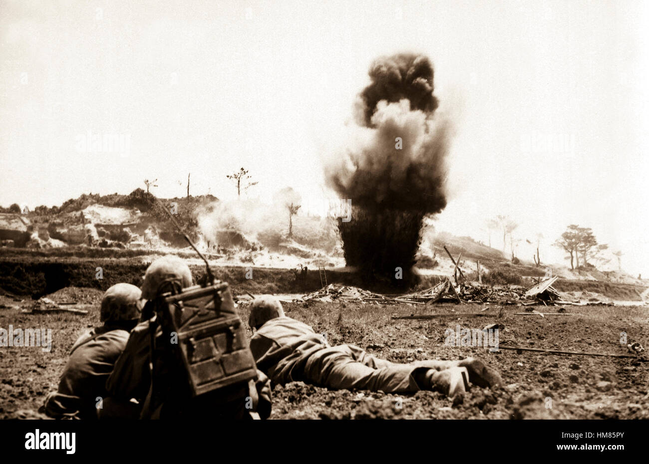 A demolition crew from the 6th Marine Division watch dynamite charges ...