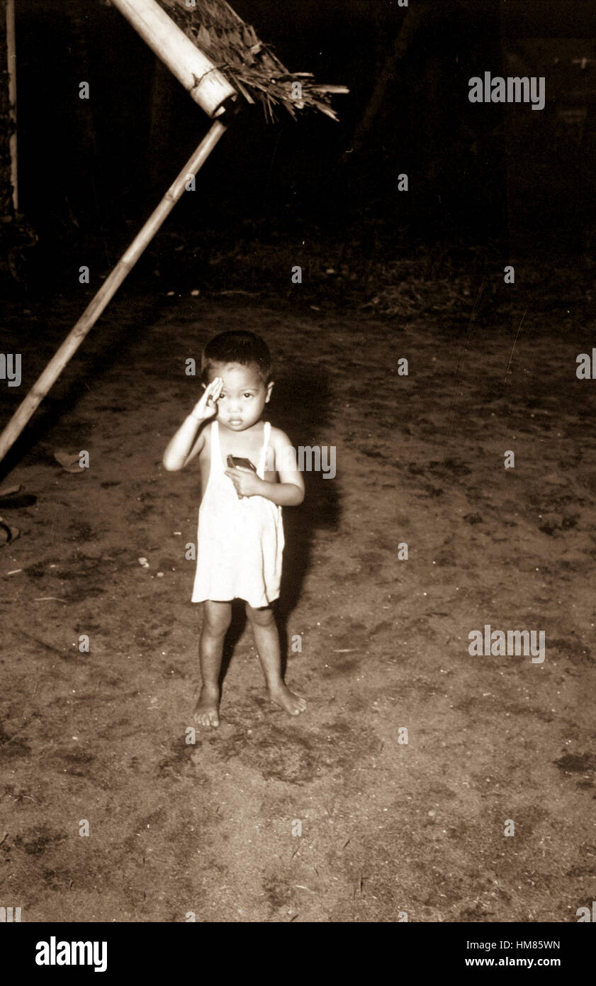 The salute was the little Filipino lad's own idea, when a Coast Guard ...