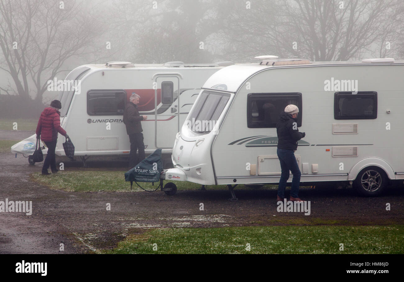 People using their touring caravan in cold foggy weather during the ...