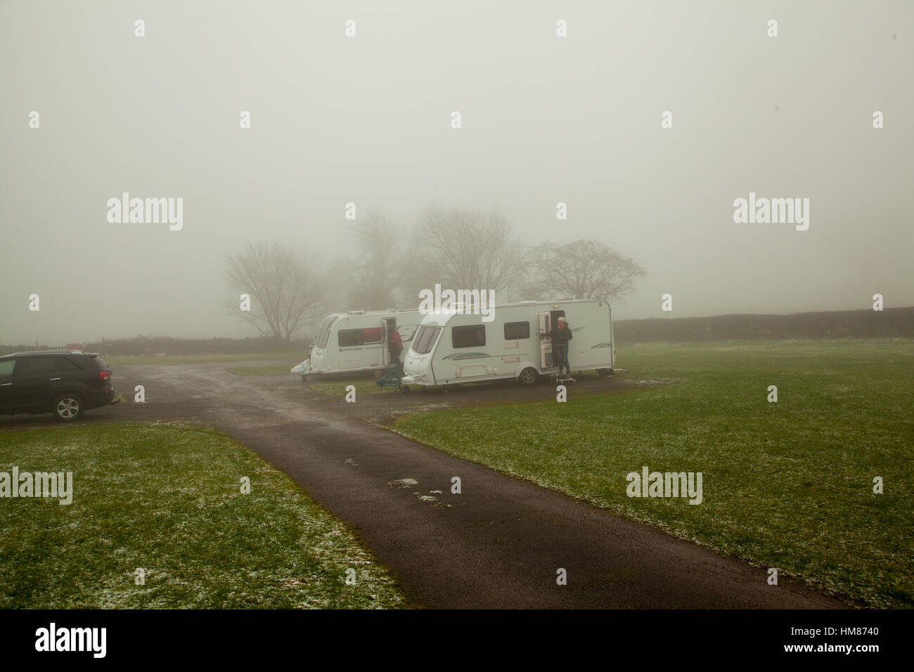 People using their touring caravan in cold foggy weather during the ...
