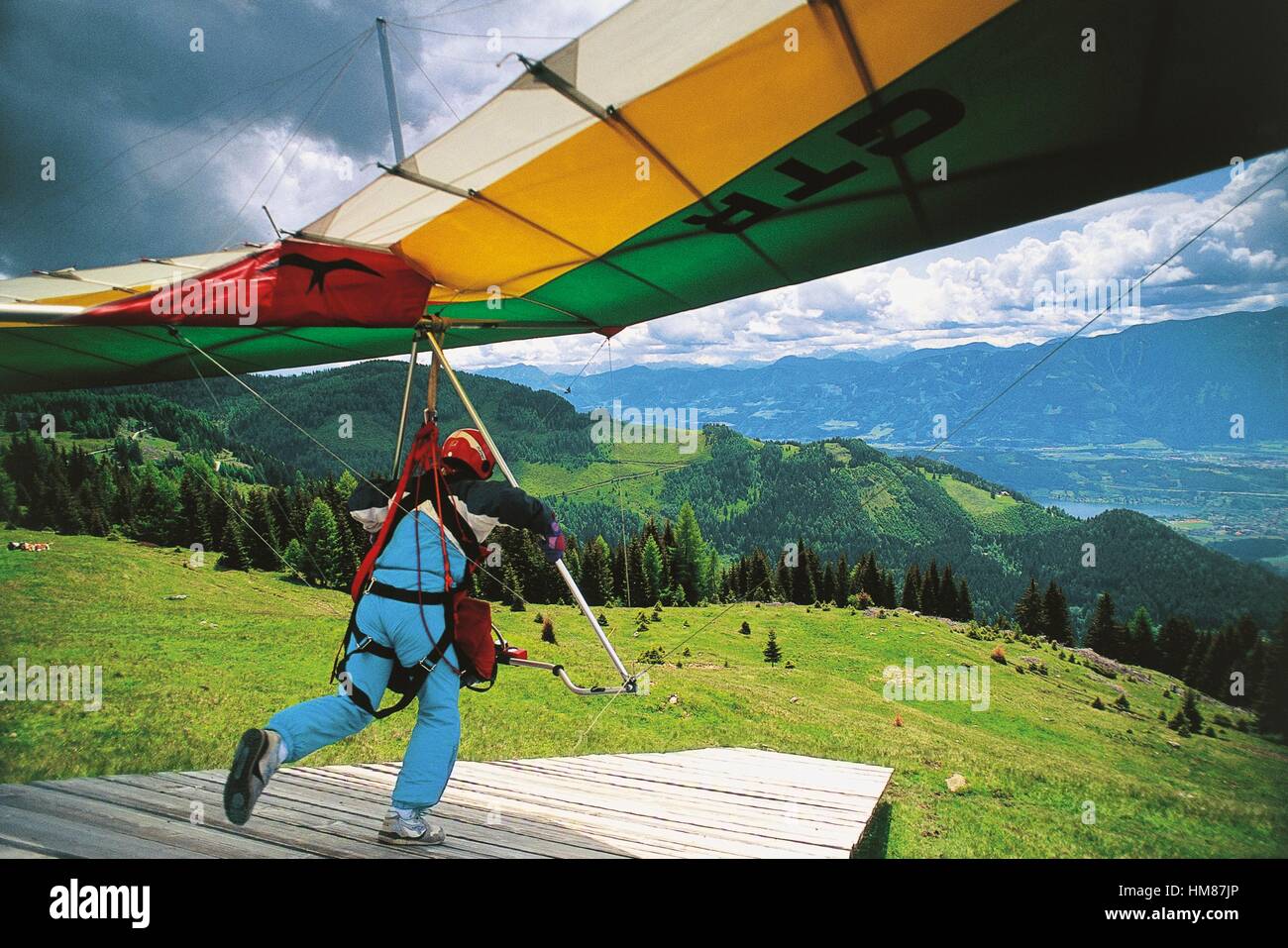 Man launching himself on a hang glider, Carinthia, Austria Stock Photo ...