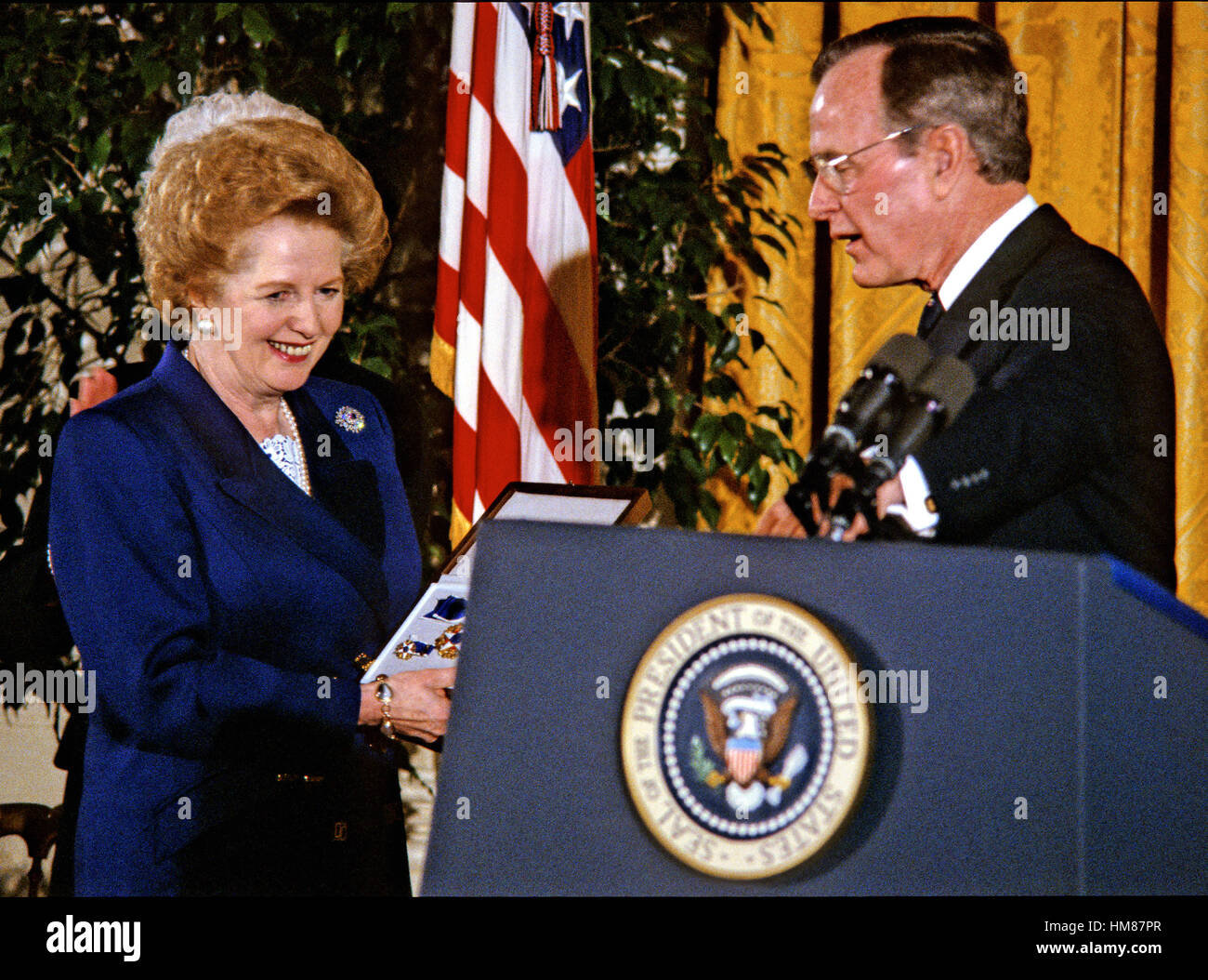United States President George H.W. Bush, right, awards the ...
