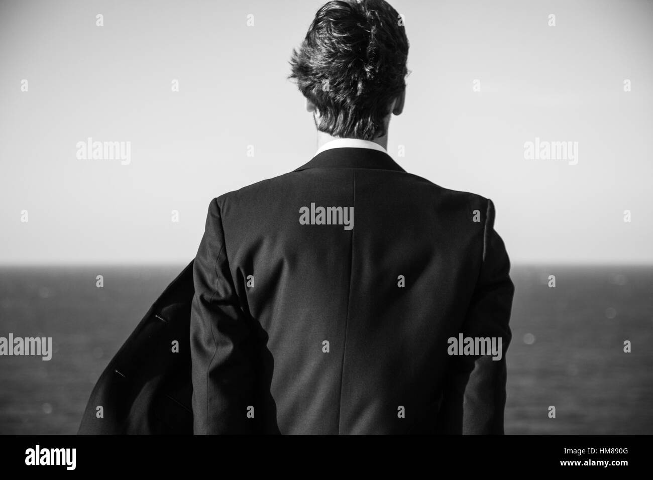 Rear View Portrait of Young Adult Man in Suit Looking out to Sea Stock ...