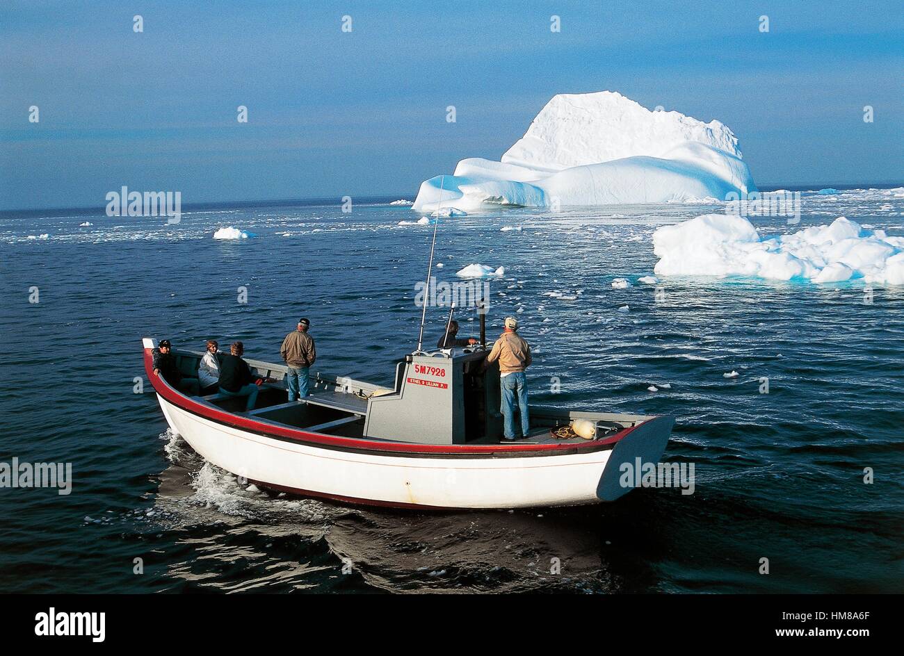 Small boat with icebergs in the background, St John bay, St John's ...