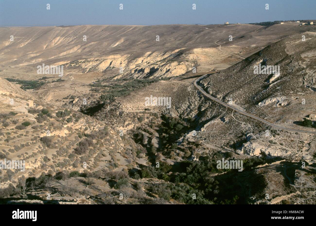 Barren landscape with a road cutting through the mountains near Sawbak ...