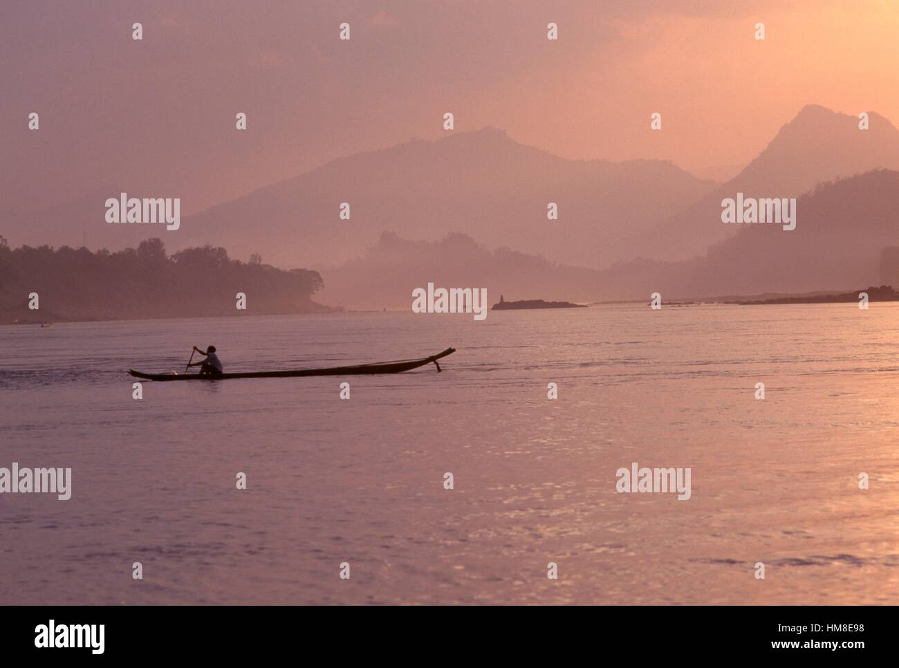 Pirogue at sunset on Mekong river, Laos Stock Photo - Alamy
