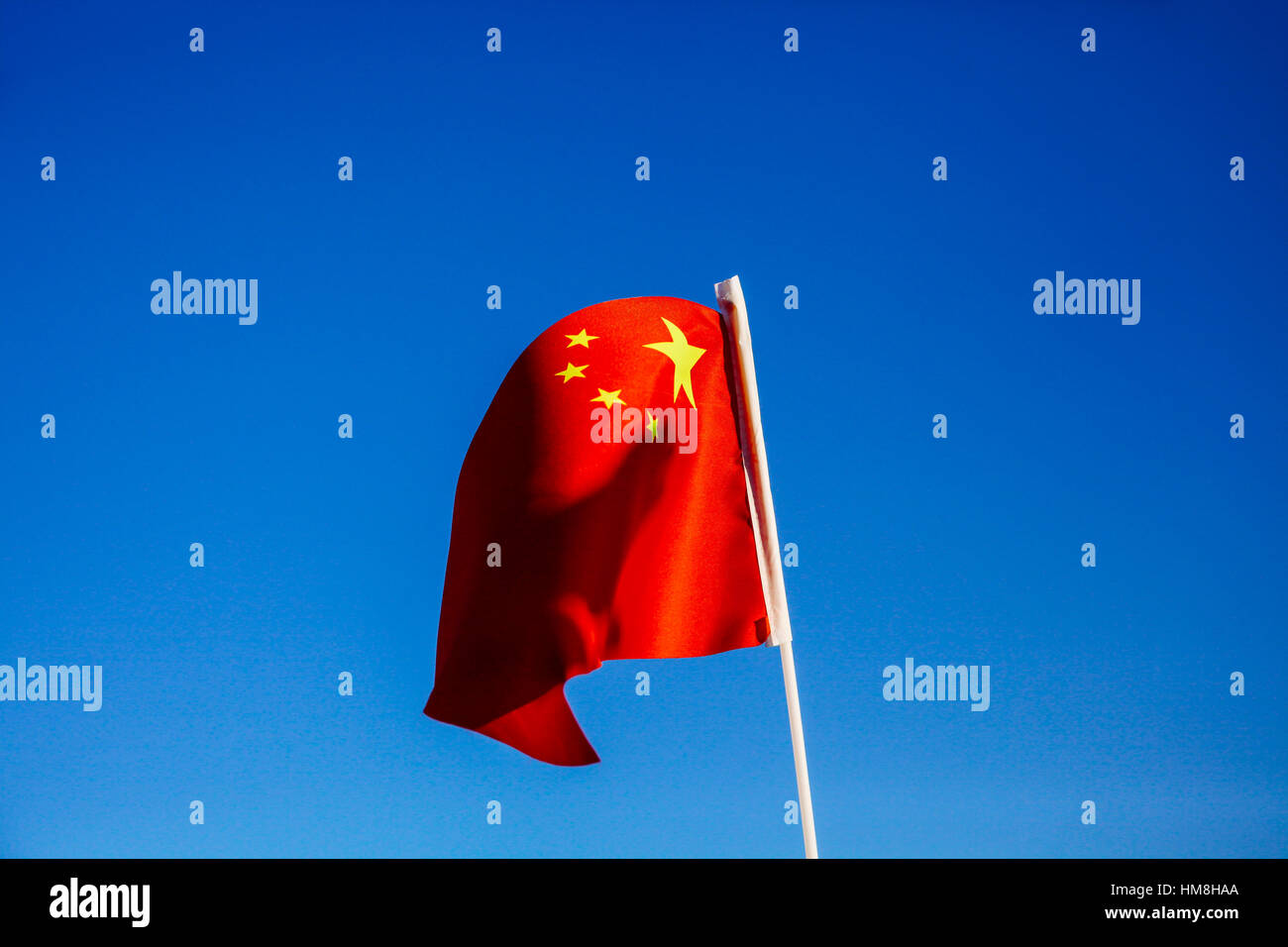 China flag waving over blue sky - country in Asia Stock Photo - Alamy
