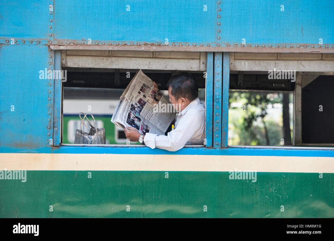 Asian man newspaper train hi-res stock photography and images - Alamy