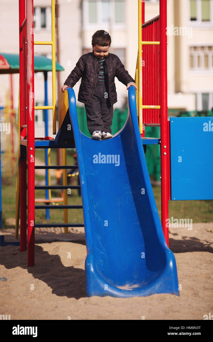 little boy playing on slide Stock Photo - Alamy