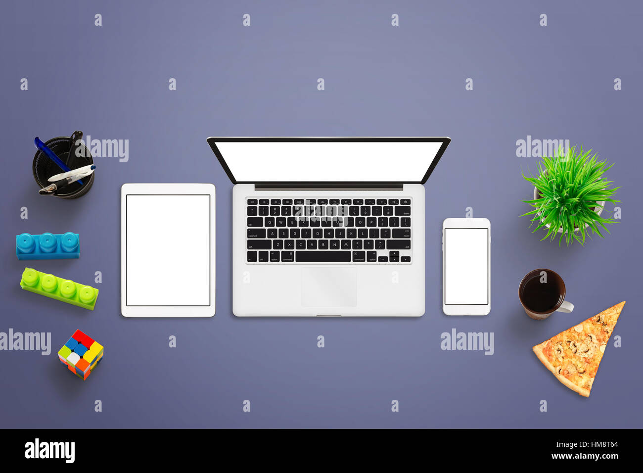 Mockup of responsive devices. Top view of desk with laptop computer ...