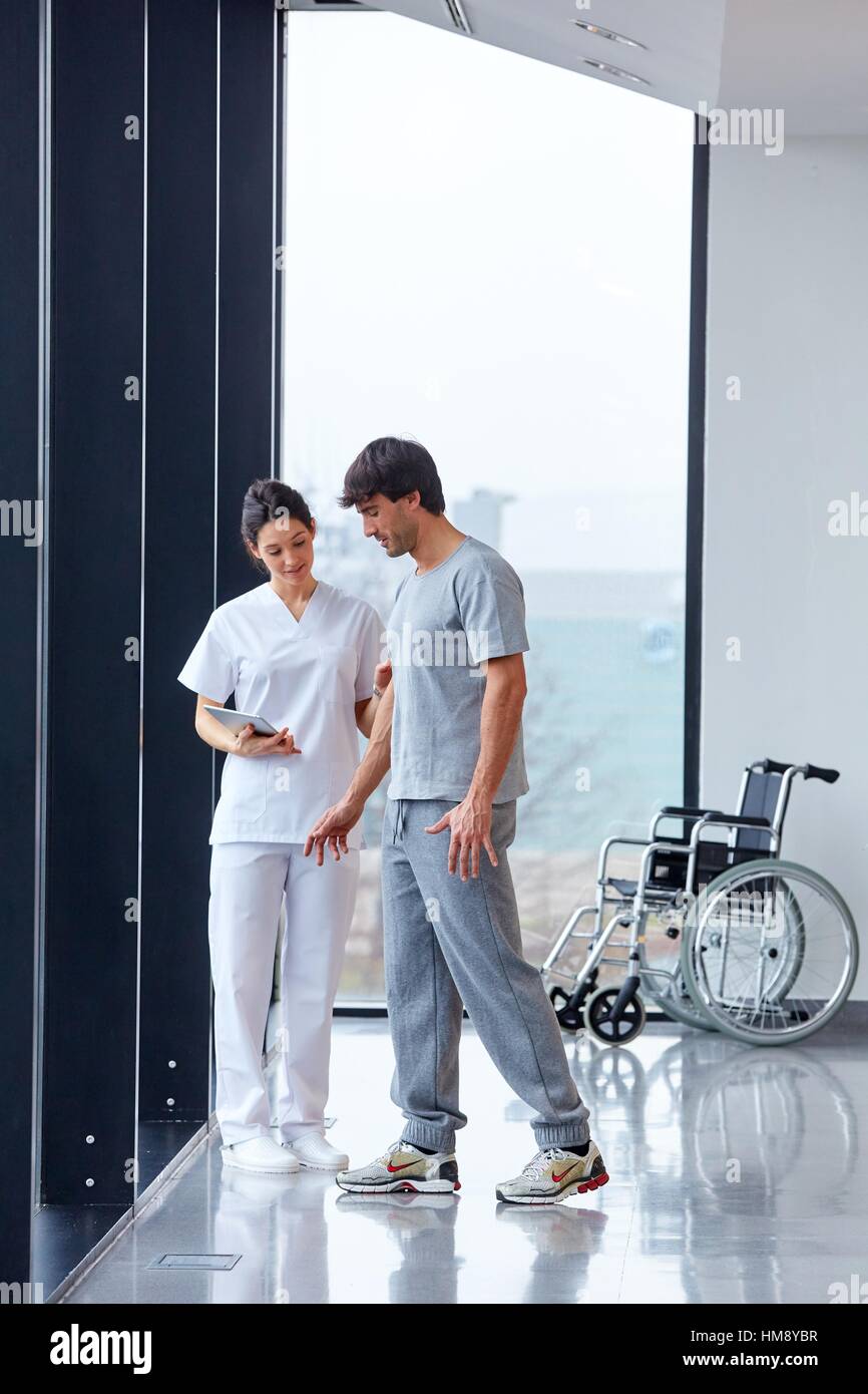 Physical therapist helping a patient to walk Stock Photo - Alamy