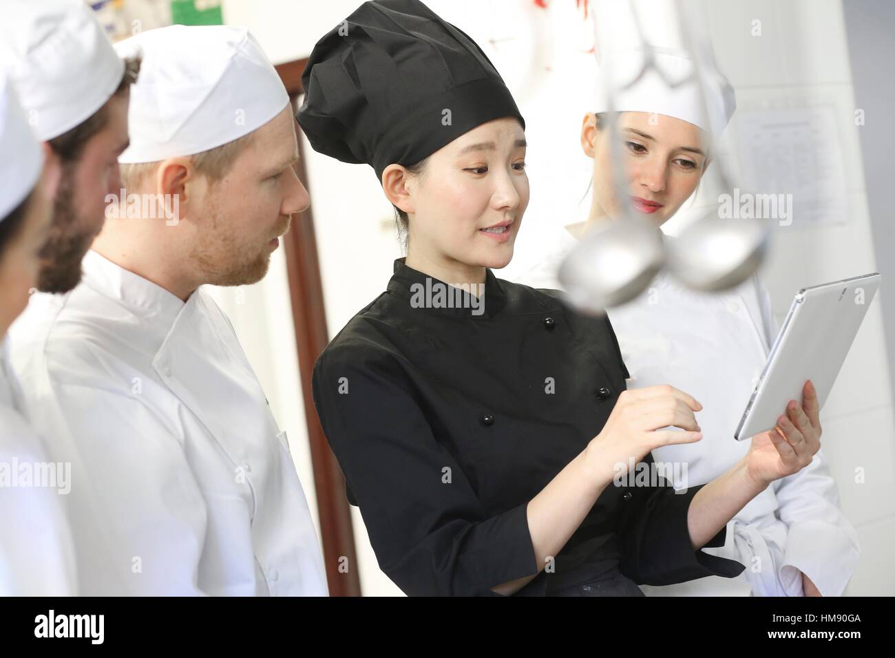 Chefs preparing menu in restaurant kitchen Stock Photo - Alamy