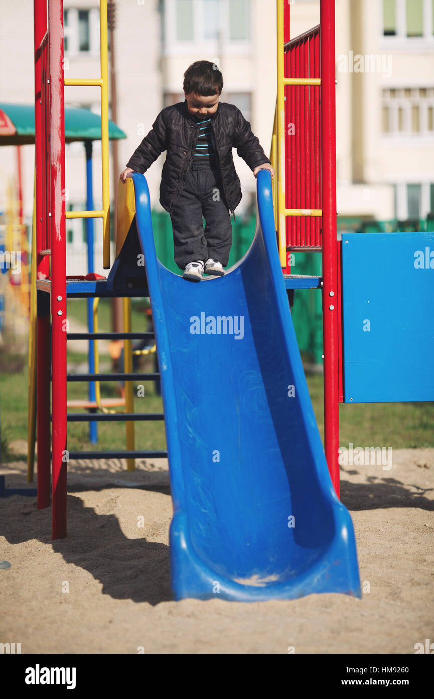 little boy playing on slide Stock Photo - Alamy