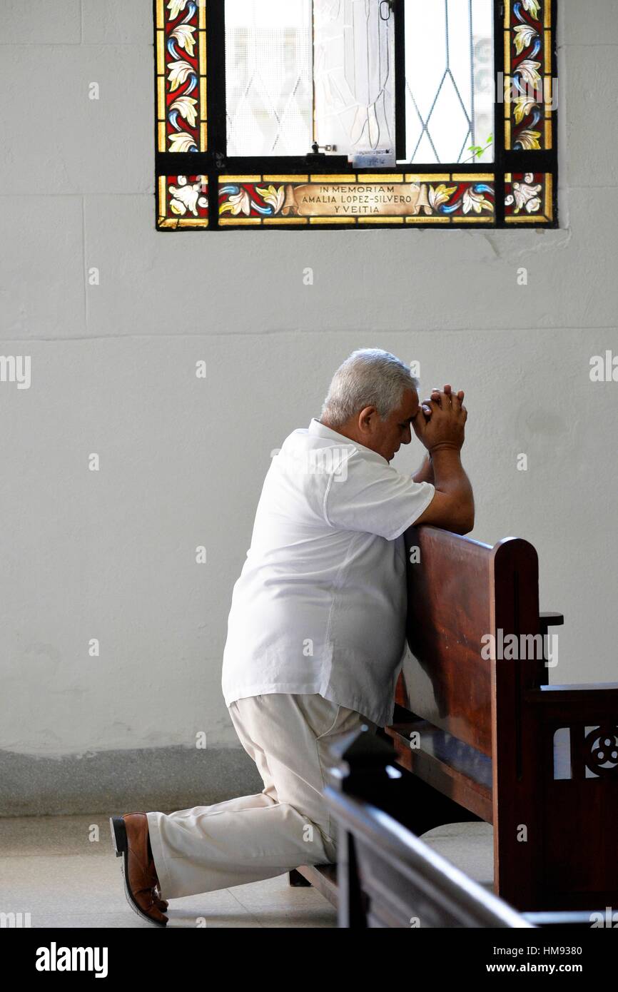 People praying inside Santa Clara´s church, Cuba Stock Photo - Alamy