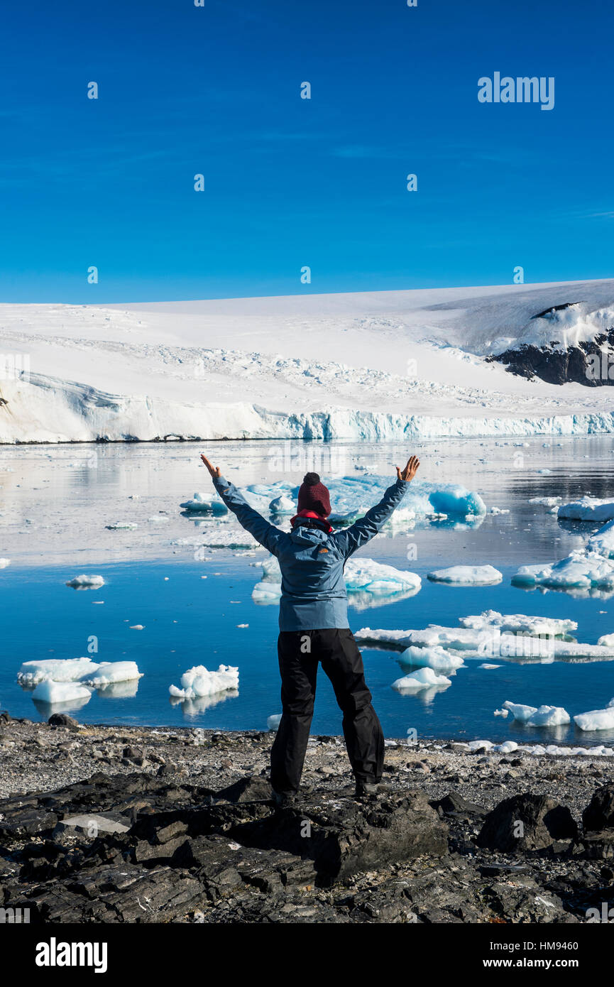 Tourist admiring the beautiful bay filled with icebergs in Hope Bay ...