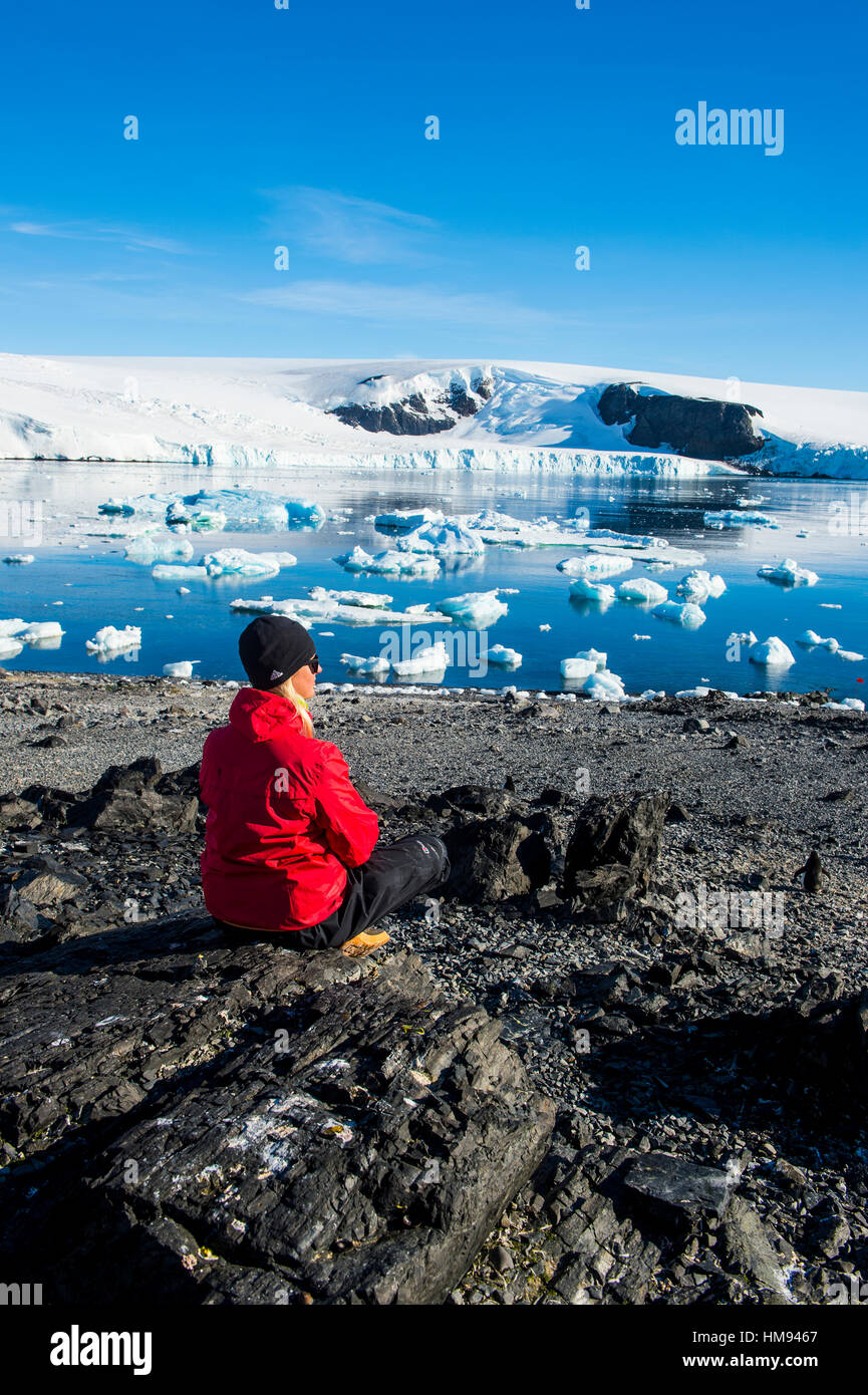 Tourist admiring the beautiful bay filled with icebergs in Hope Bay ...