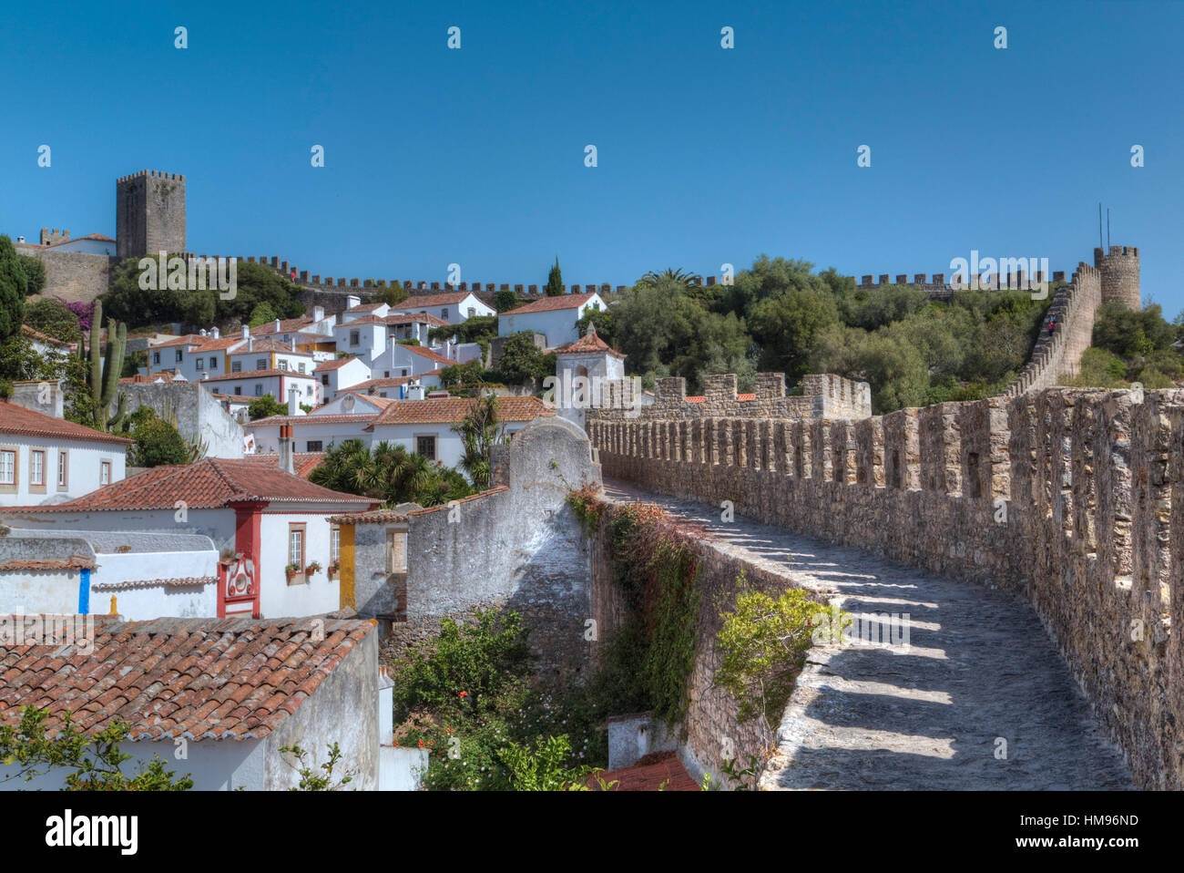 City overview with Wall and Medieval Castle in the background, Obidos ...