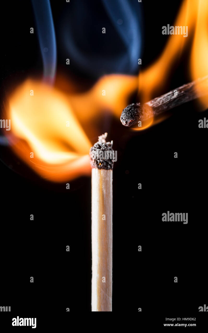 Two matches flaring up Stock Photo - Alamy