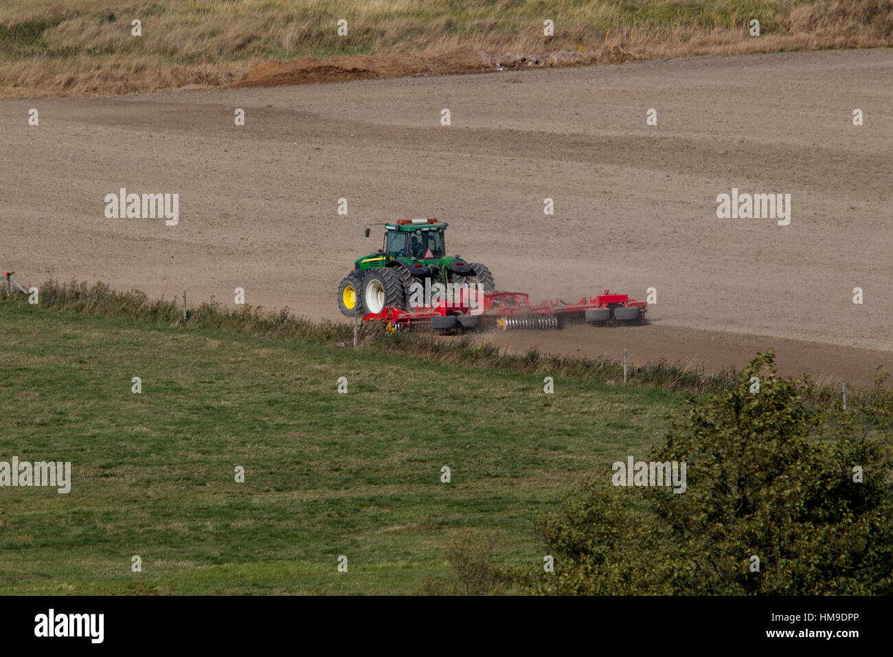 Farmer working in his field with a large tractor Stock Photo - Alamy