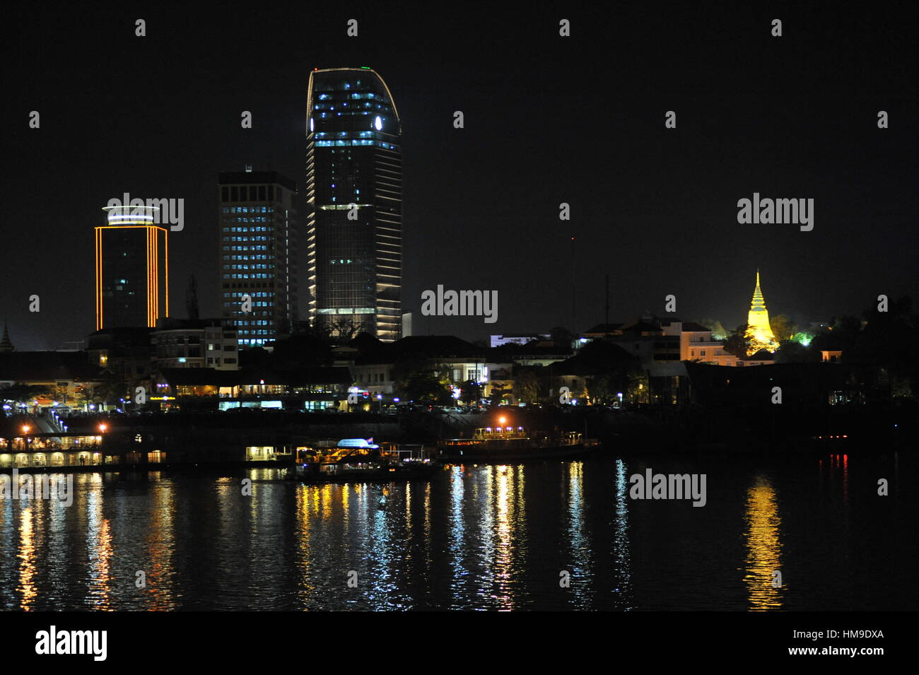 Phnom Penh skyline reflected in the Tonle Sap River at night, Cambodia ...