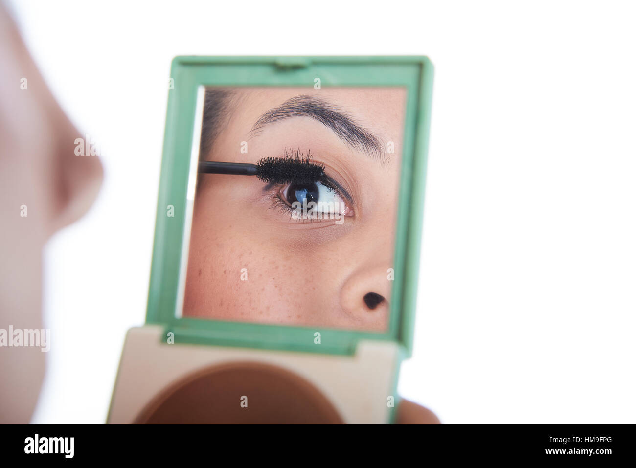 reflection of girl's eyes while applying mascara Stock Photo - Alamy