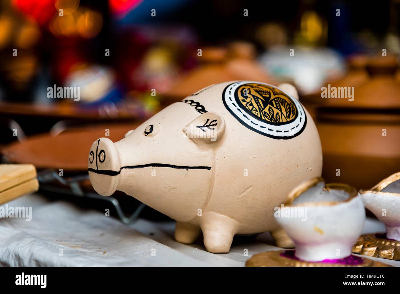 A beautiful hand made and painted clay piggy bank for sale at a shop ...