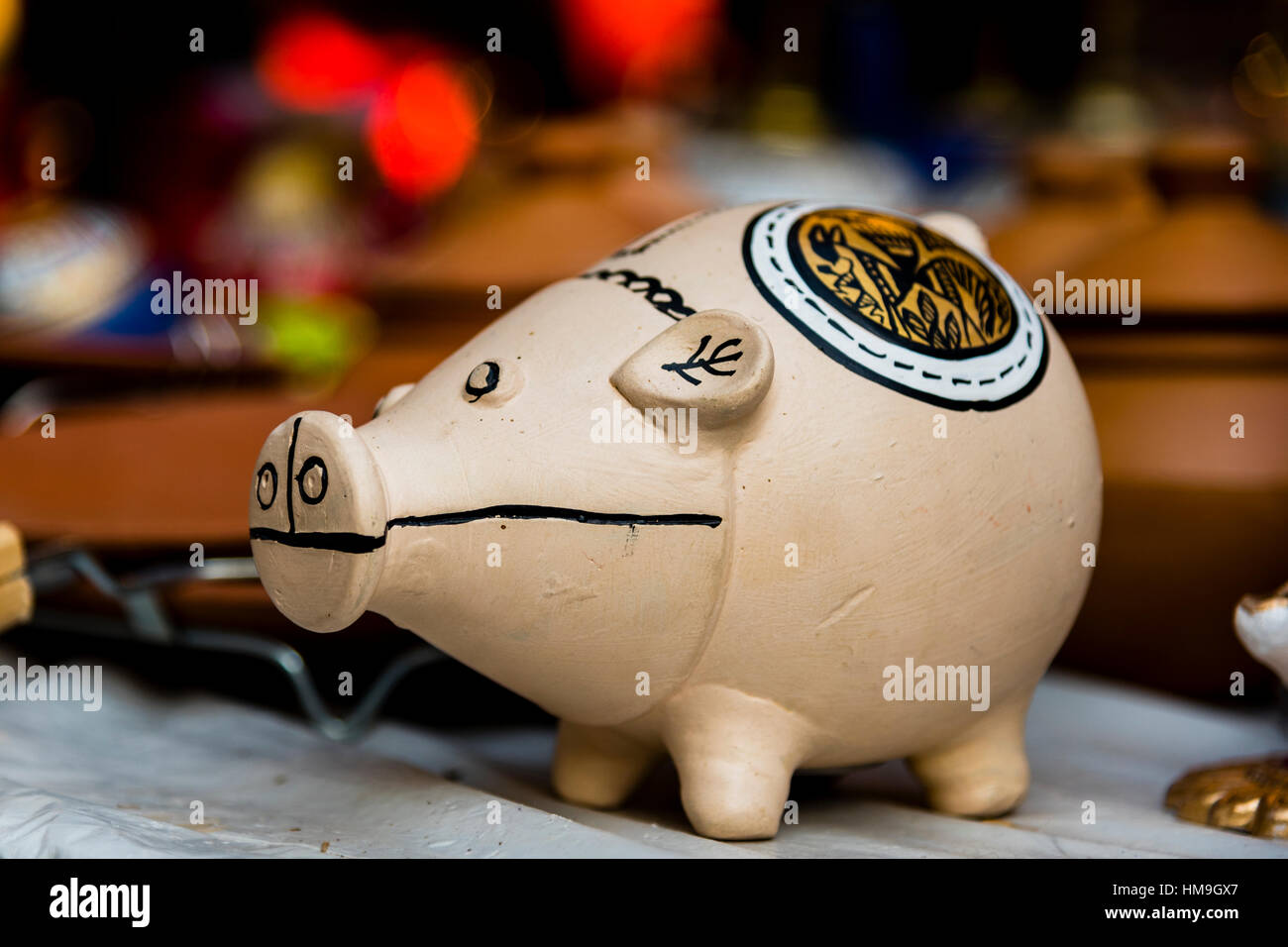 A beautiful hand made and painted clay piggy bank for sale at a shop ...