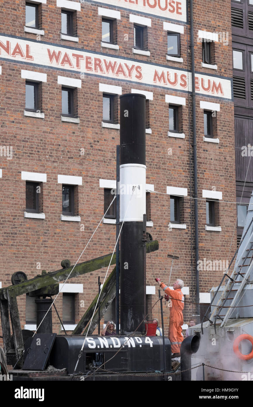 Volunteers working on a historic steam dredger in Gloucester docks ...