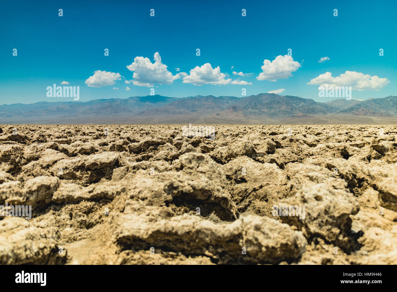 Cracked salt brine ground texture with blue sky, bad water section of ...