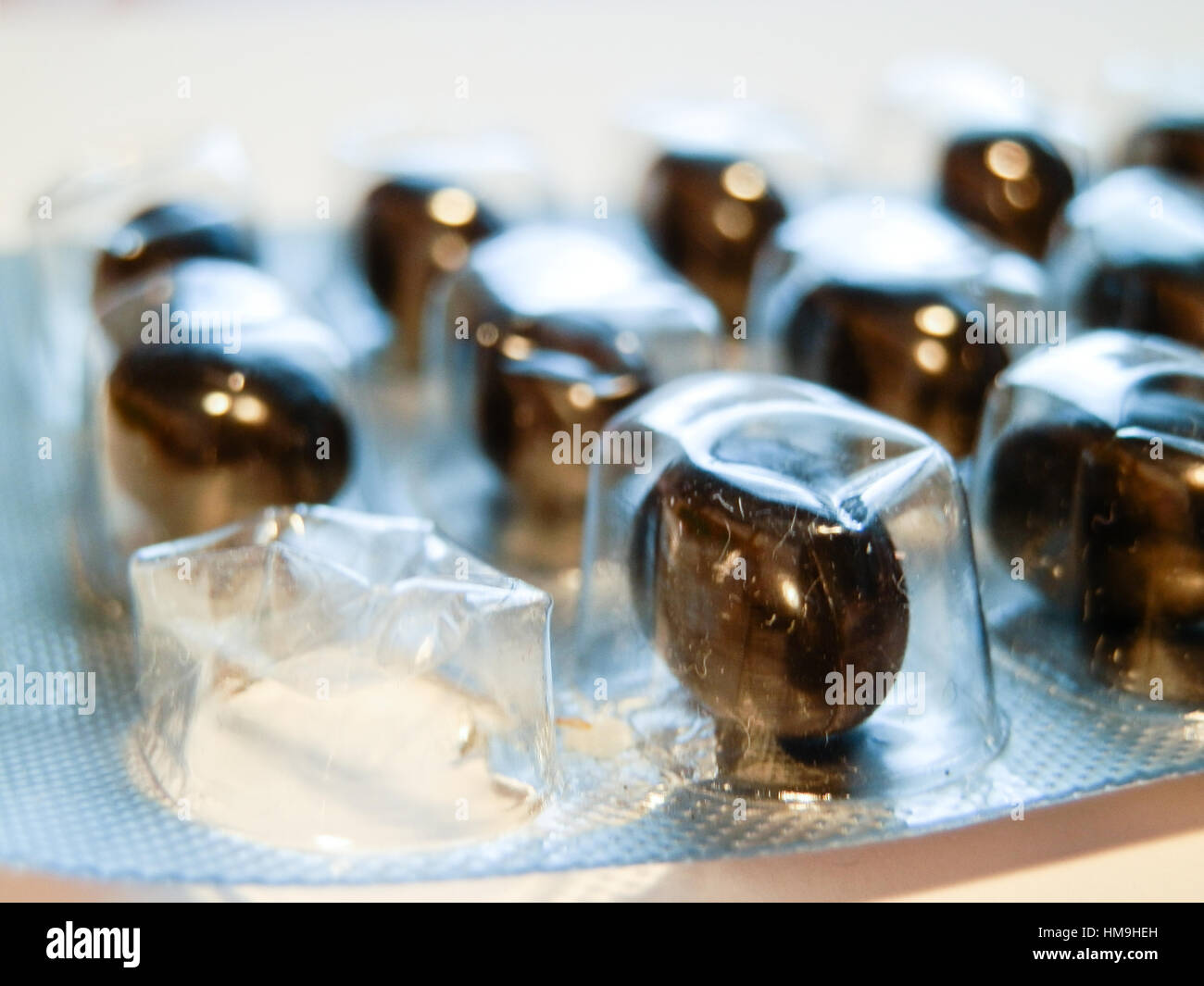 Pack of black pill drugs Stock Photo - Alamy