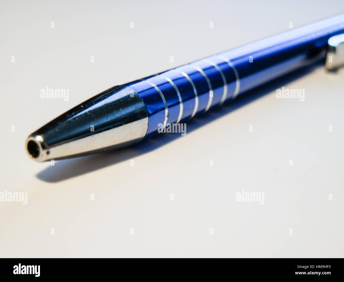 Sharp blue steel pen macro on white backround. 4 Stock Photo - Alamy