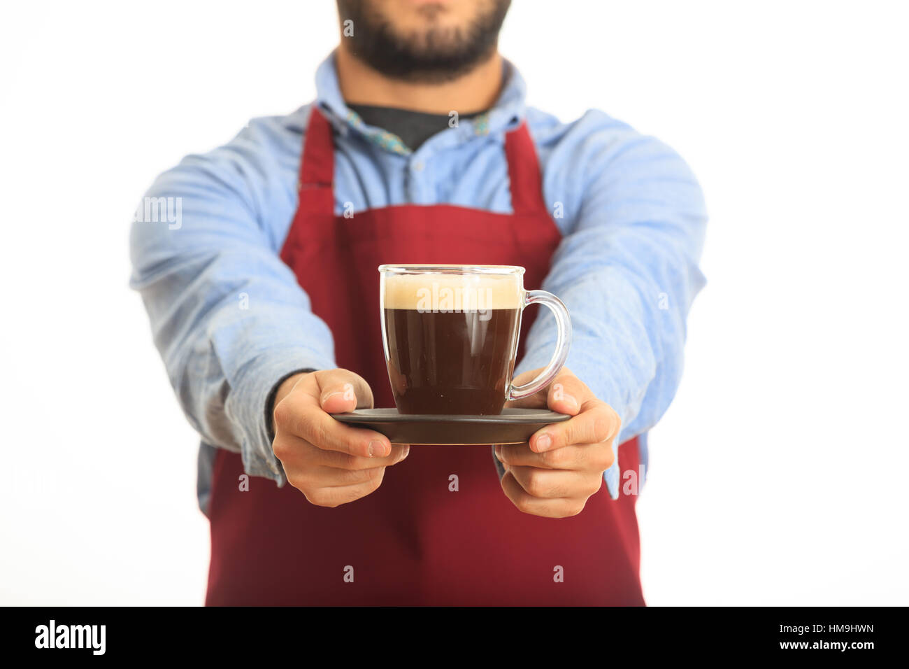 Young man offering a cup of coffee on white background Stock Photo - Alamy