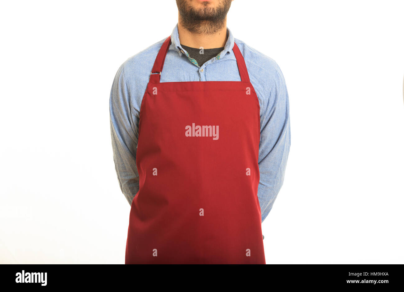 Young man with red apron on white background Stock Photo - Alamy
