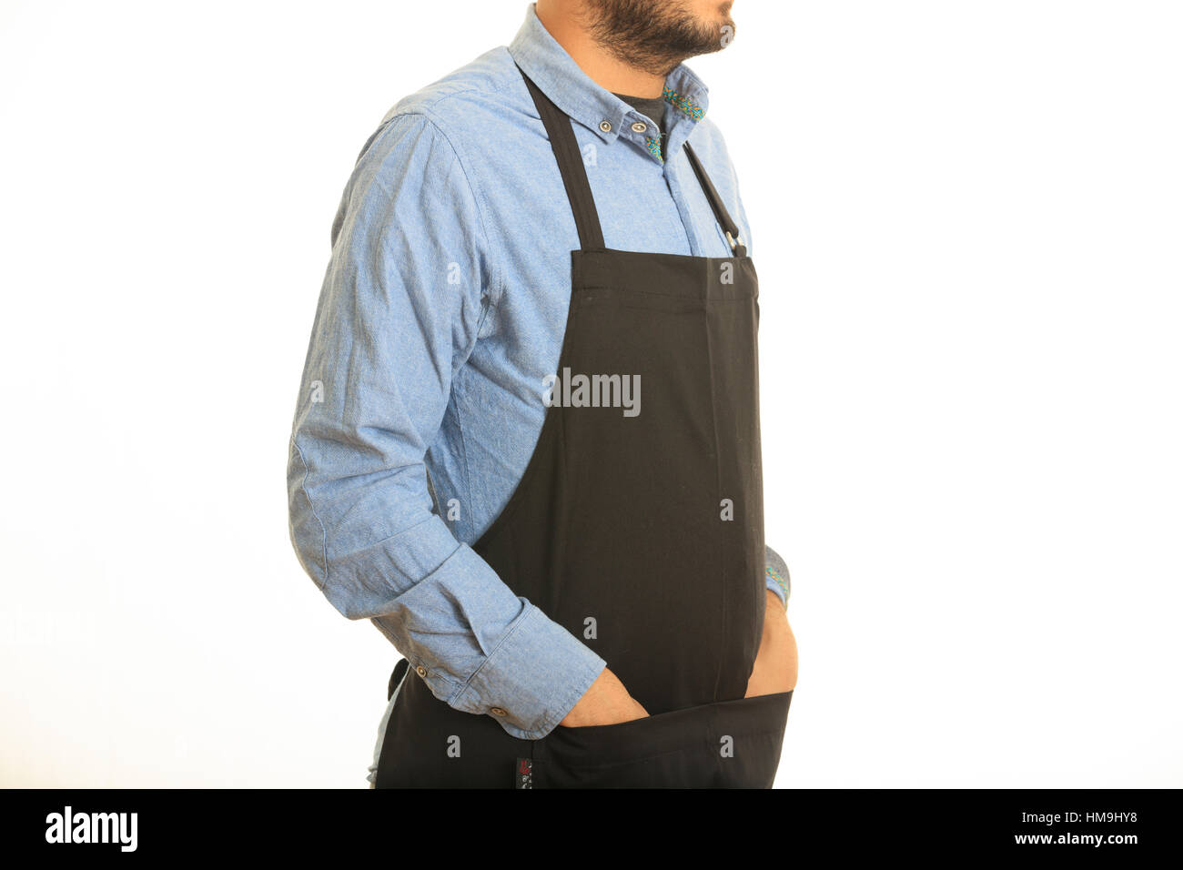 Young man with black apron on white background Stock Photo - Alamy