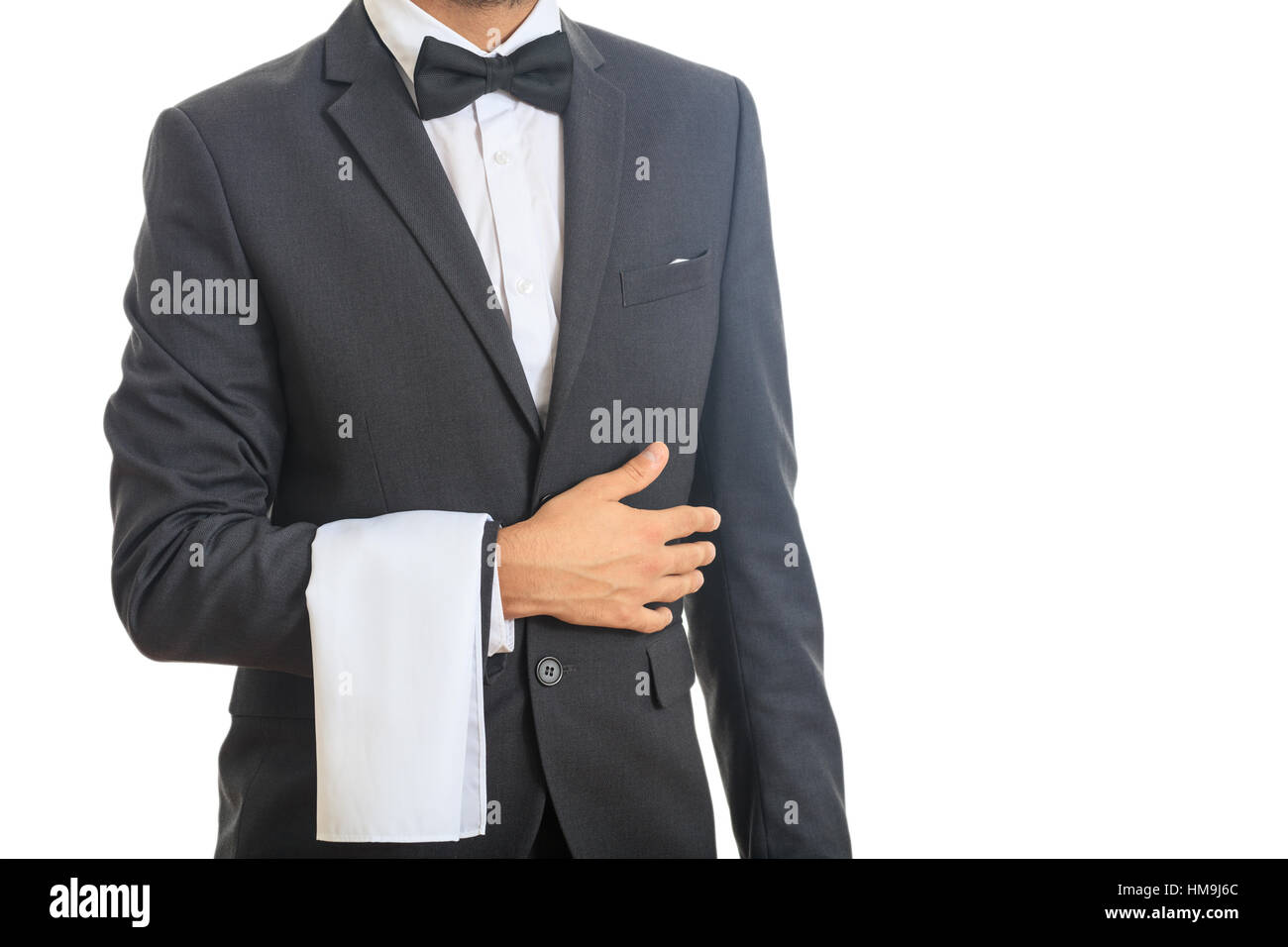 Waiter with bow tie standing Stock Photo - Alamy