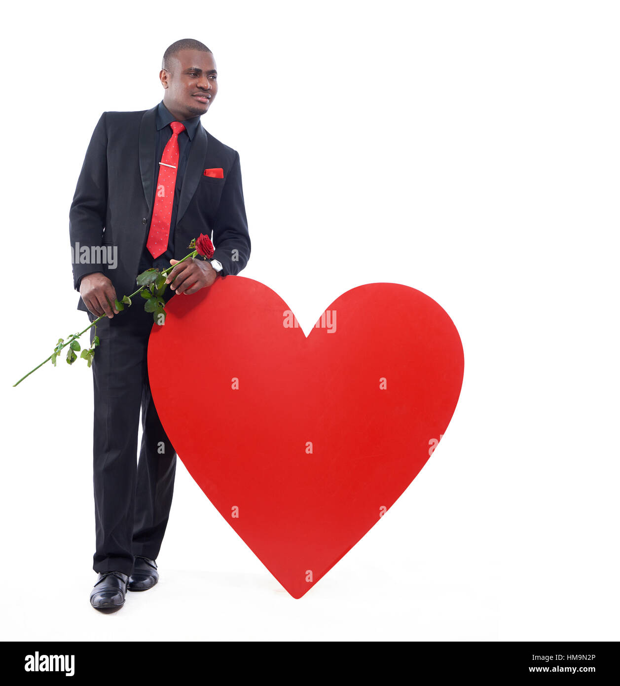 Business man and leaning of big heart at studio Stock Photo - Alamy