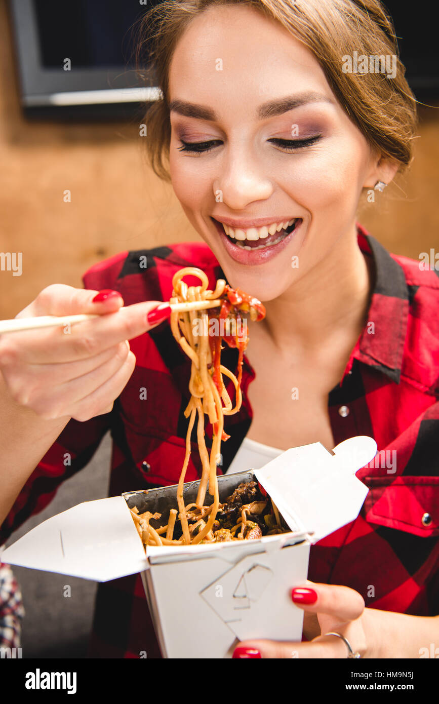 Woman eating noodles hi-res stock photography and images - Alamy