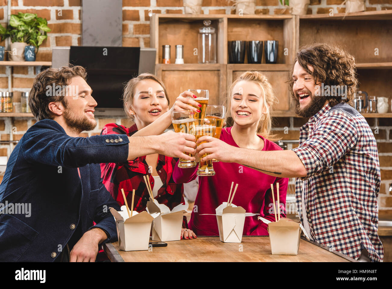 Happy friends drinking beer Stock Photo - Alamy