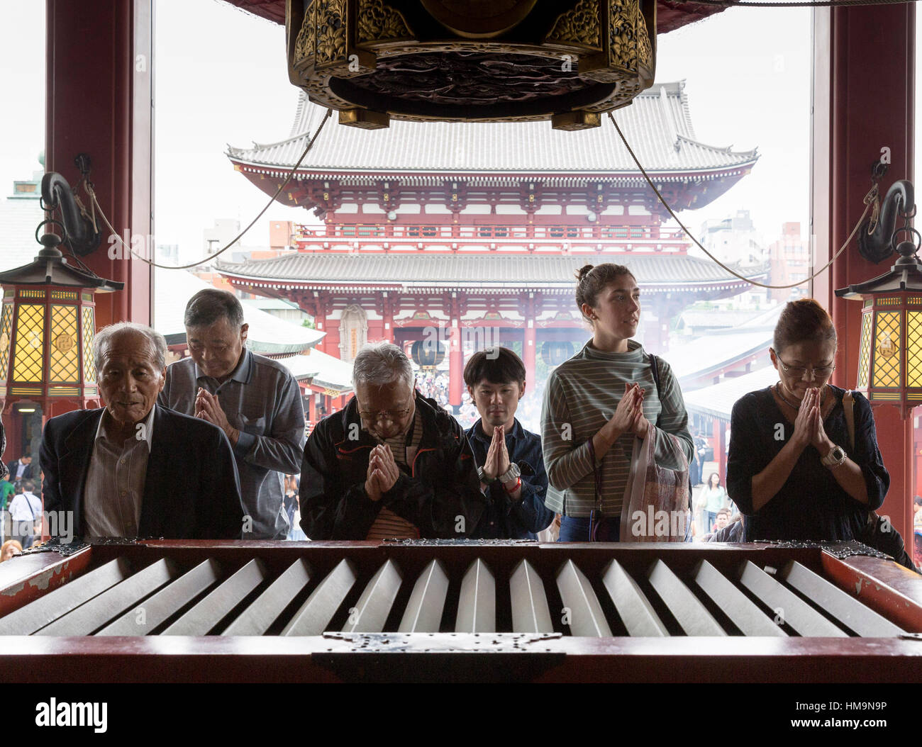 Visitors praying in Senso-ji Temple, Asakusa, Taito City, Tokyo, Japan ...