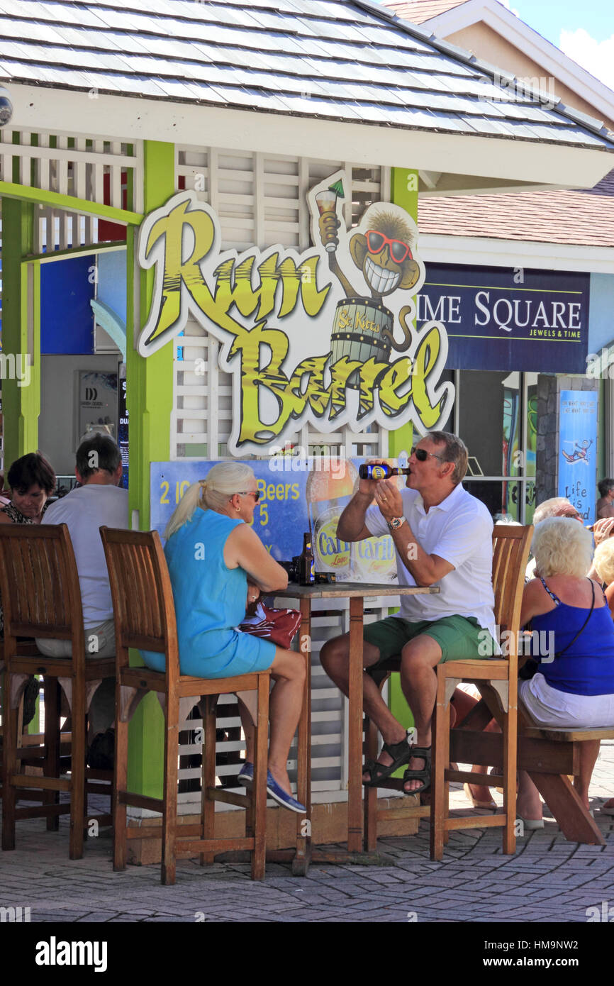 Middle aged couple drinking at Rum Barrel bar, Port Zante, Basseterre ...