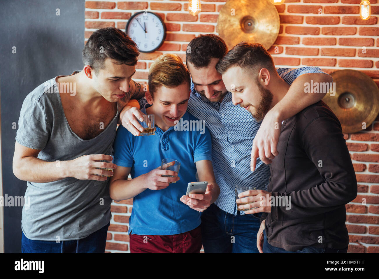 Cheerful old friends communicate with each other and phone watch ...