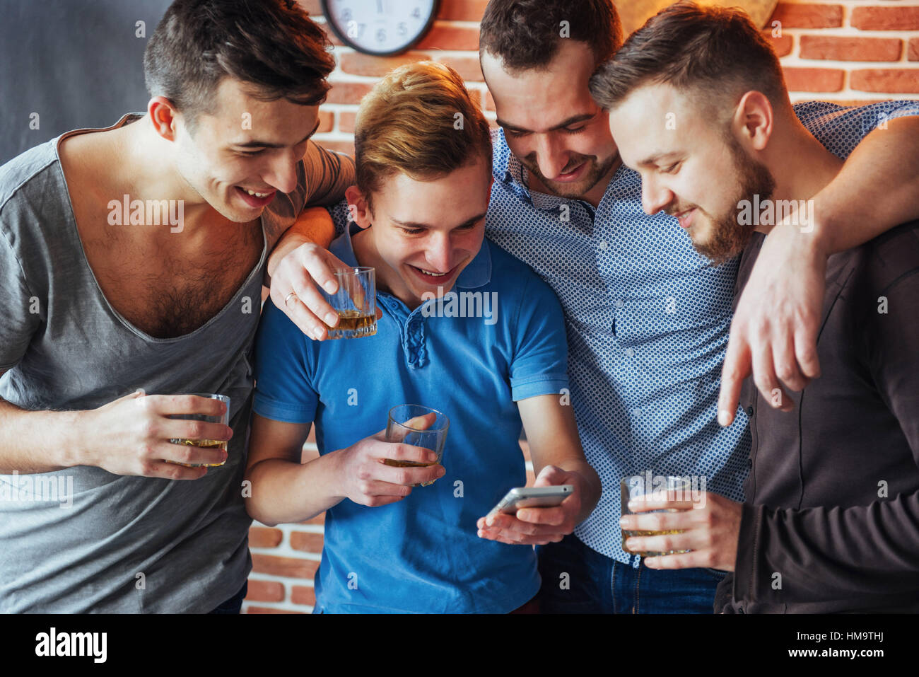 Cheerful old friends communicate with each other and phone watch ...